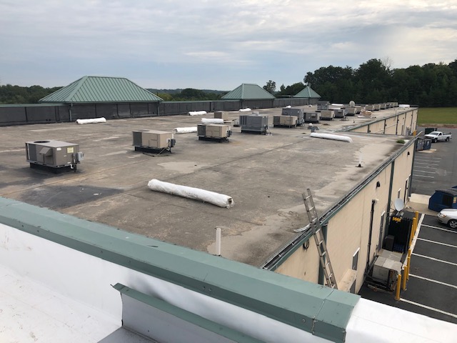 How to Spot Early Signs of Commercial Roof Damage - Bel Air Foam & Roofing